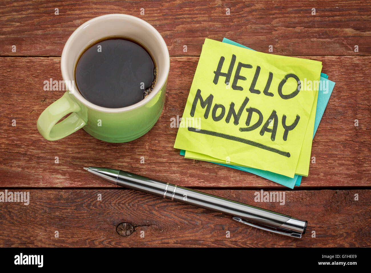 Hello Monday cheerful handwriting on sticky note with cup of coffee ...