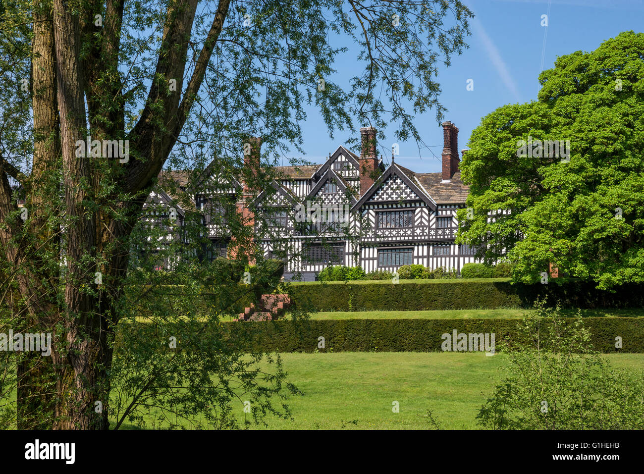 Bramall Hall near Stockport, surrounded by beautiful parkland. A willow ...
