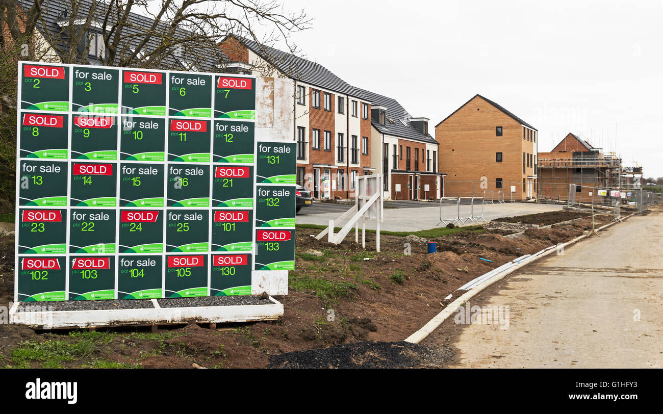 Board displaying status of new built homes with defocussed houses in ...