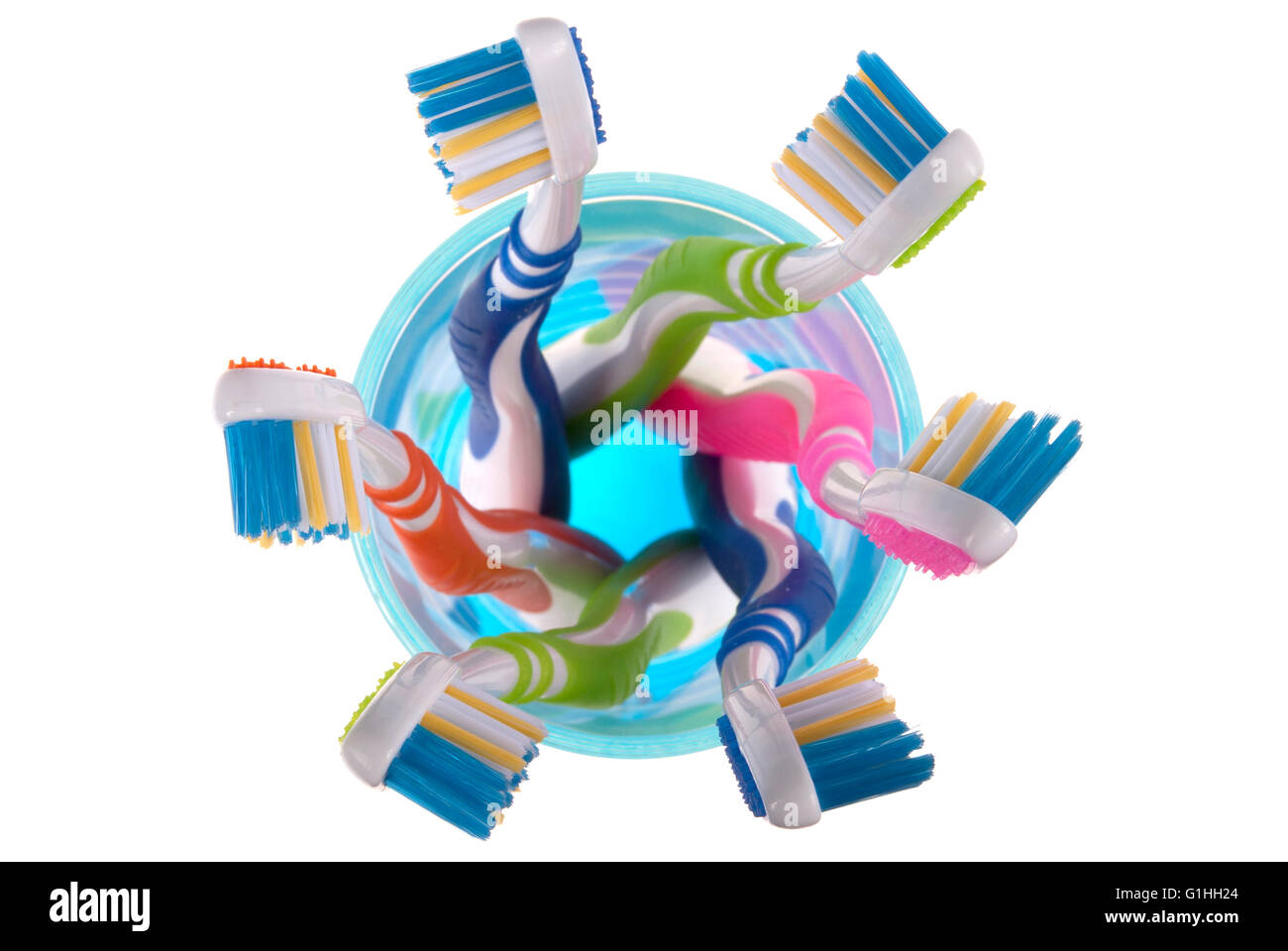 Colored toothbrushes in glass. Isolated on white background. Clipping ...