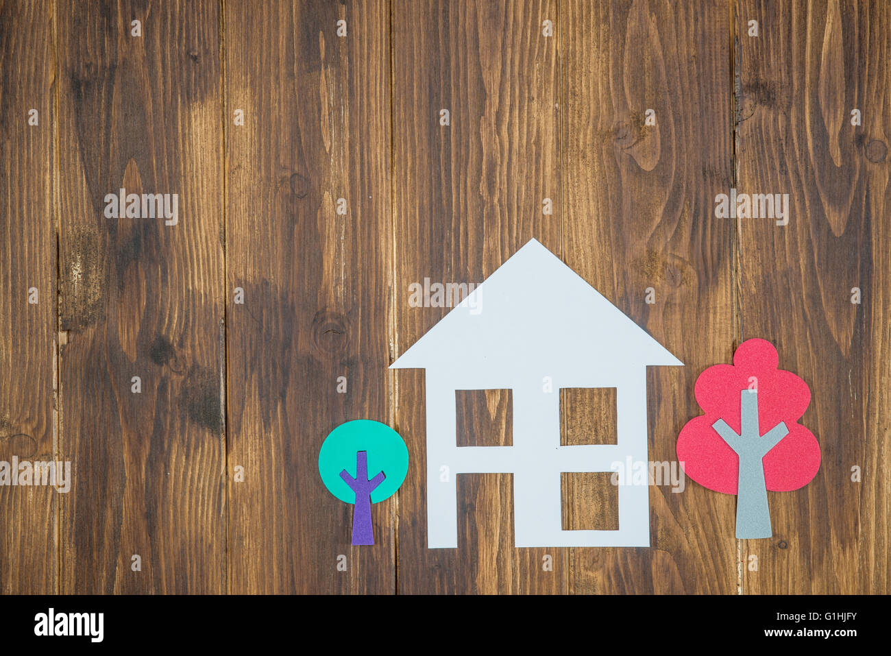 Paper houses and trees, home green environment Stock Photo - Alamy