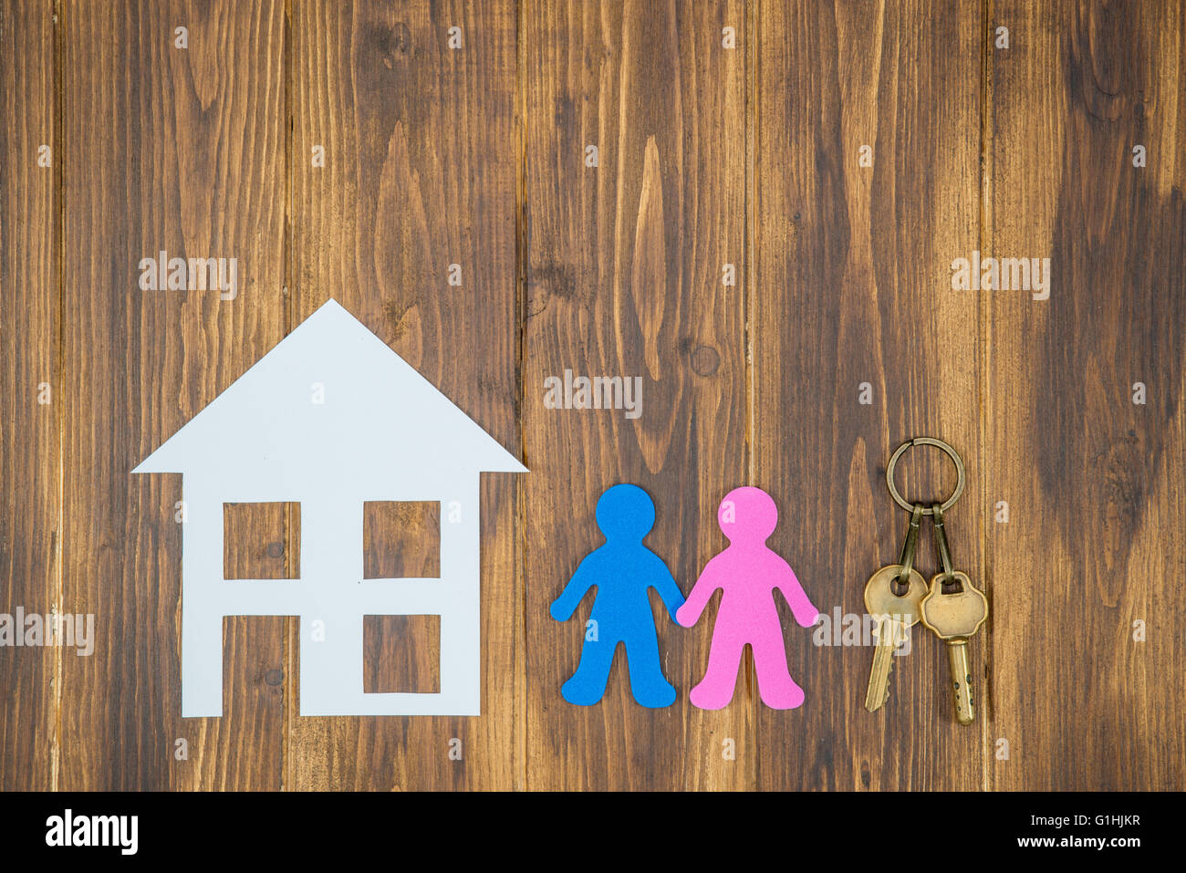 couple buy a new house, paper house with key on wooden background Stock ...