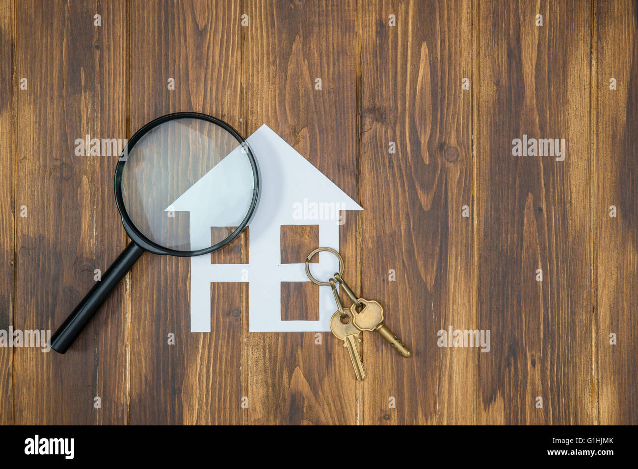 paper house and key with Magnifying Glass, House hunting on wooden ...