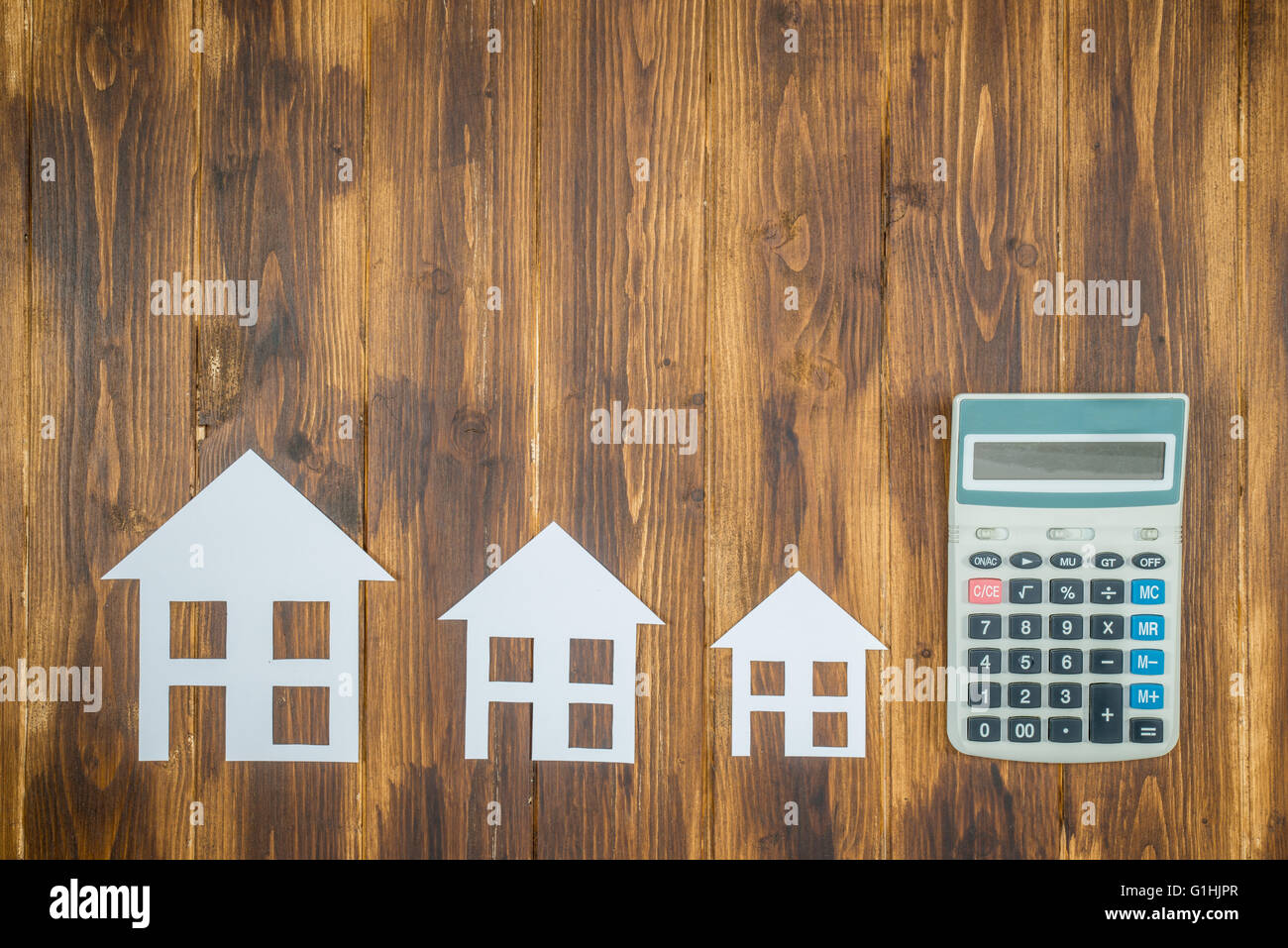 house and Calculator on wooden background Stock Photo - Alamy