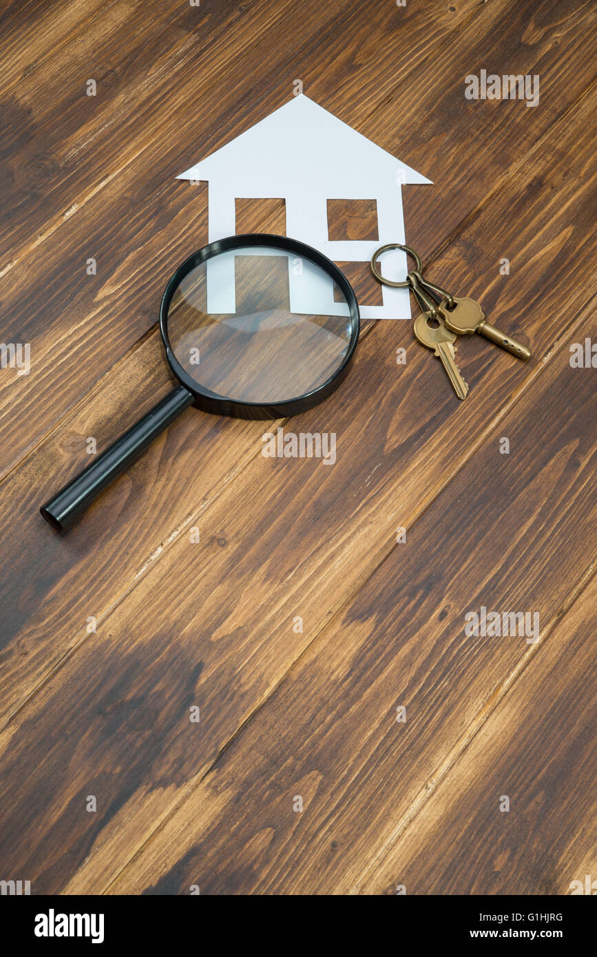 paper house and key with Magnifying Glass, House hunting on wooden ...