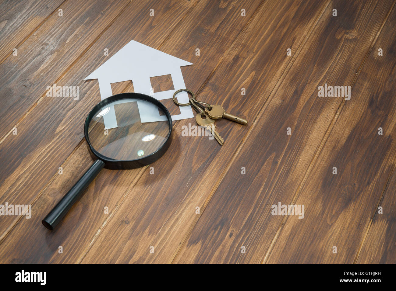 paper house and key with Magnifying Glass, House hunting on wooden ...