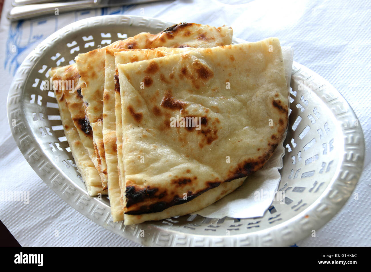 Close up of freshly made Naan bread in a metal bowl Stock Photo - Alamy
