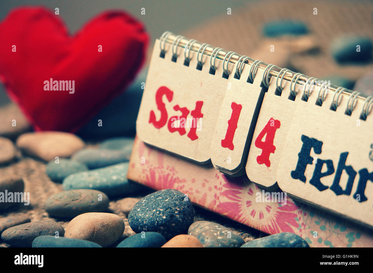 Red heart, symbol of love with desk calendar, Feb 14 on it, nice pebble ...