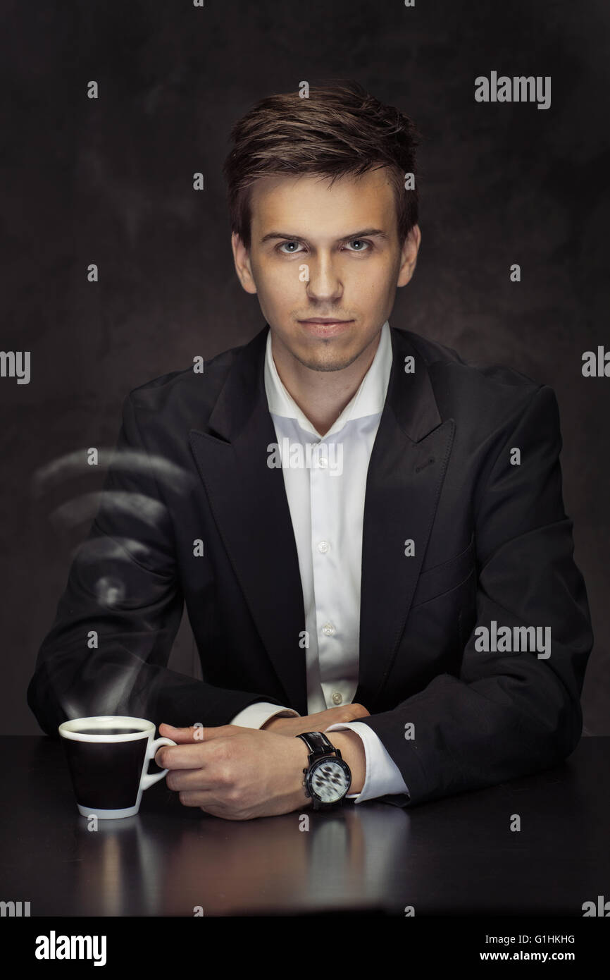 Elegant young guy drinking the vaporous coffee with the WiFi sign Stock ...