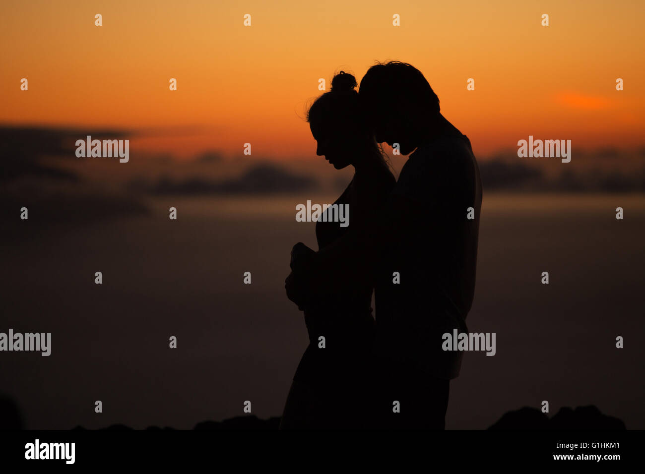 Silhouettes of the calm, young couple Stock Photo - Alamy