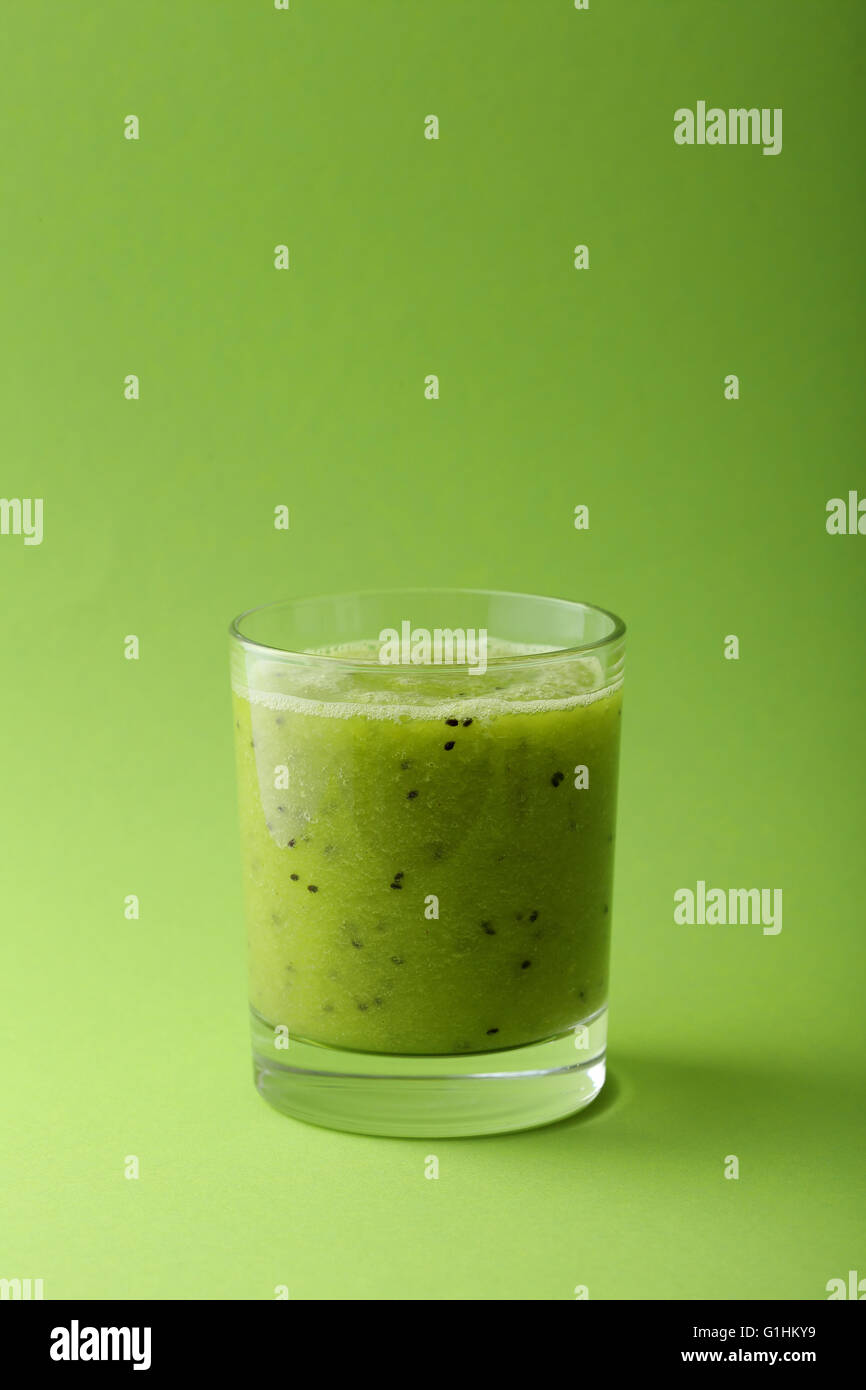 fresh green fruits cocktail on green background Stock Photo - Alamy