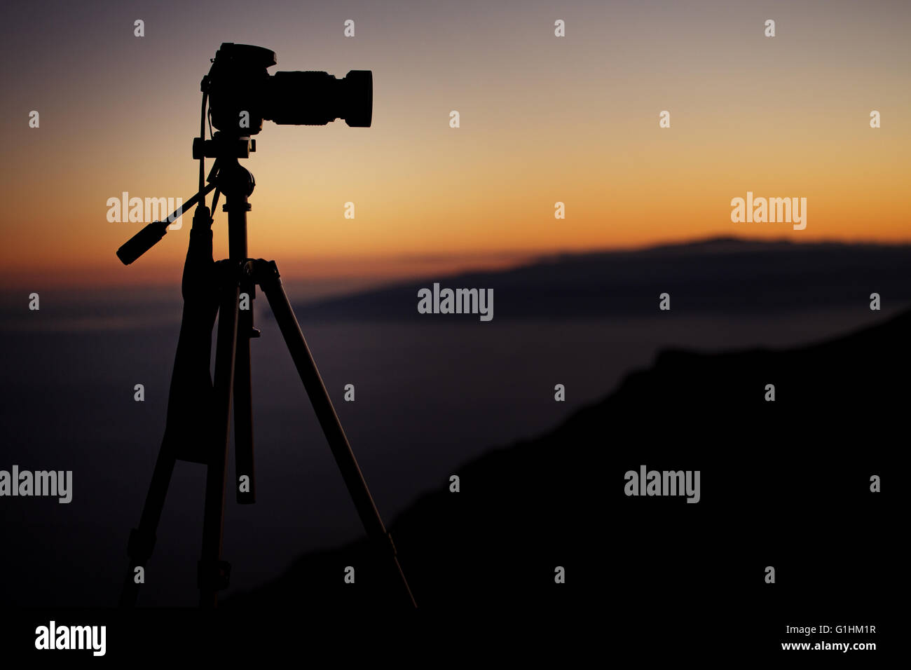 Professional digital camera over the sunset background Stock Photo - Alamy