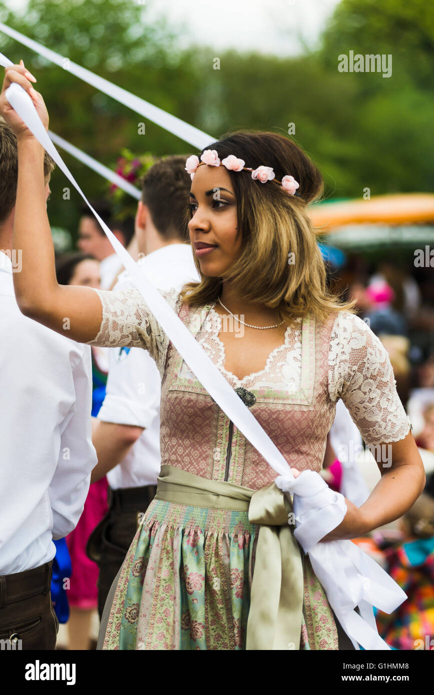 Portrait of a dark-skinned young woman in a dress dancing a traditional ...