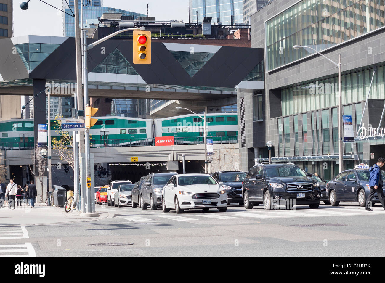GO train traveling over lower Simcoe St. at Bremmer Blvd with commuters ...