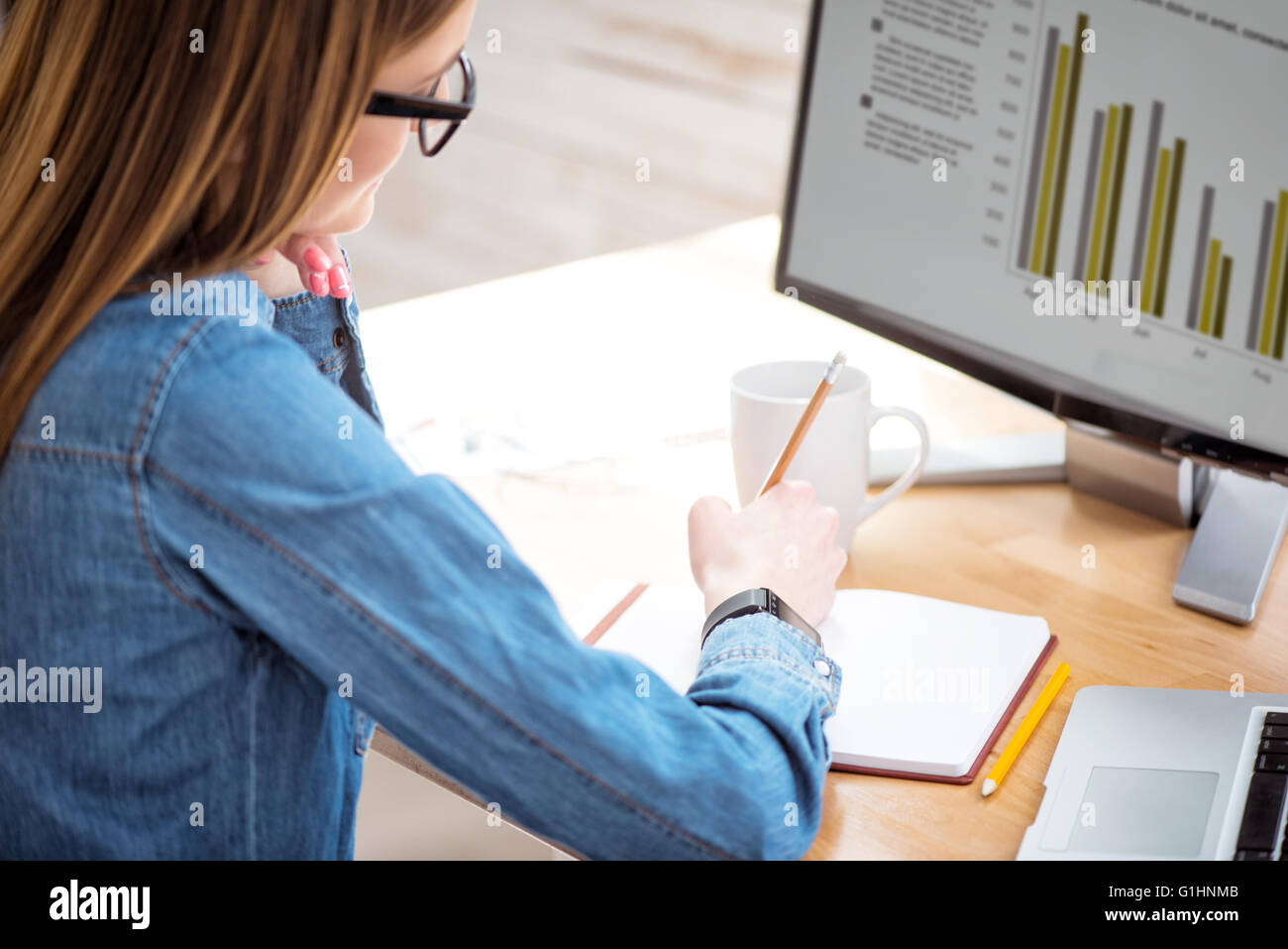 Positive woman sitting at the table Stock Photo - Alamy