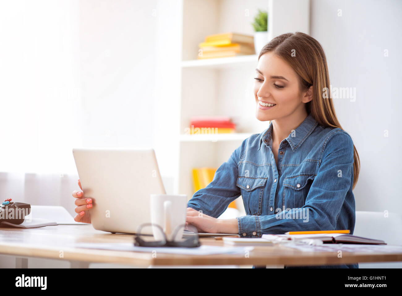 Delighted female sitting table laptop hi-res stock photography and ...