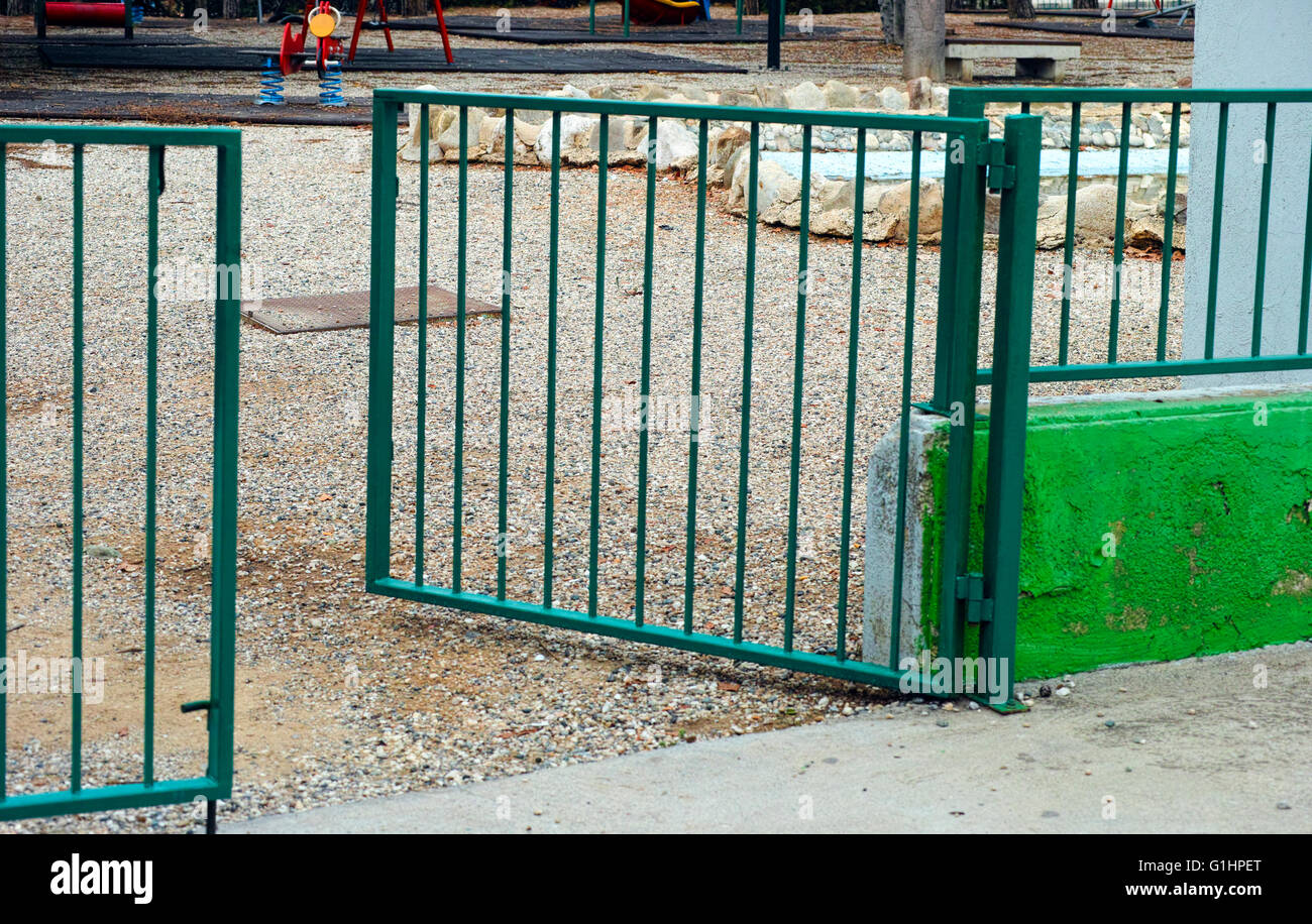 Open gate to playground. Focus is on the ground Stock Photo - Alamy