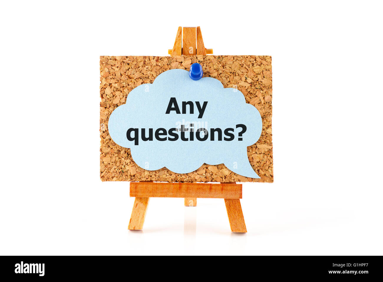 Wooden easel with corkboard and blue speech bubble with words Any ...