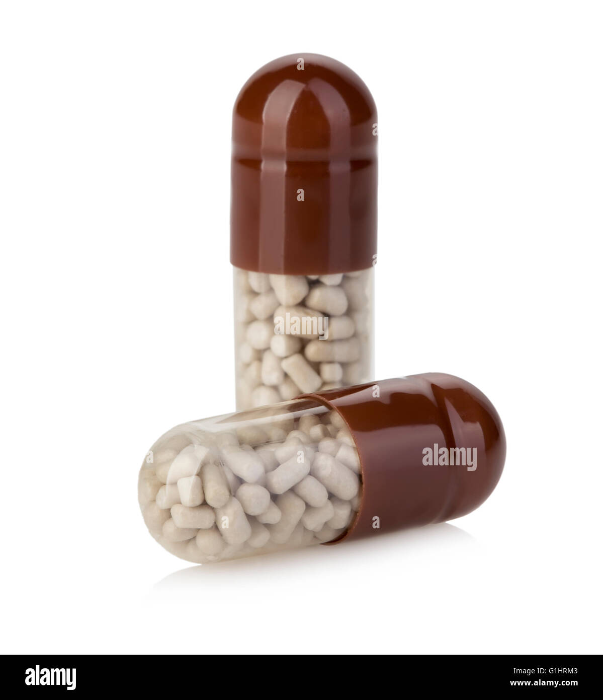 Brown capsules, pills close-up on a white background Stock Photo - Alamy