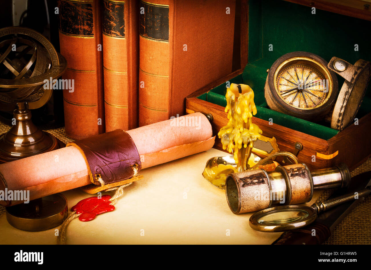 Old books, candle, spyglass, old scroll with red wax seal, vintage ...