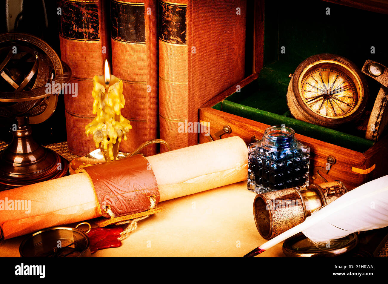 Old books, burning candle, spyglass, old scroll with red wax seal ...