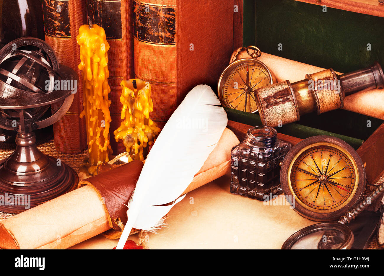 Old books, feather pen and ink bottle, old scroll with red wax seal ...