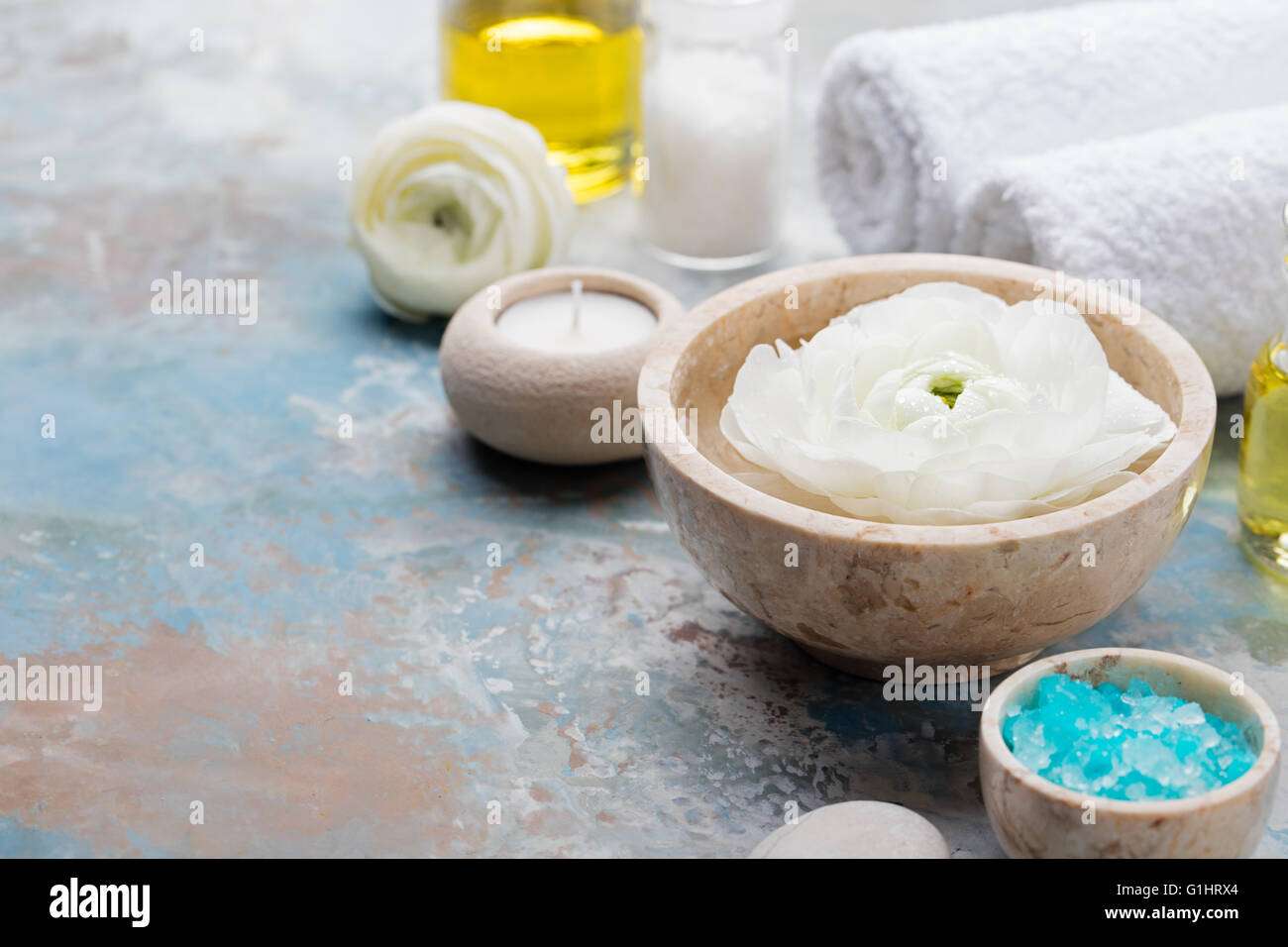 Spa and wellness massage setting, white floating ranunculus flowers ...
