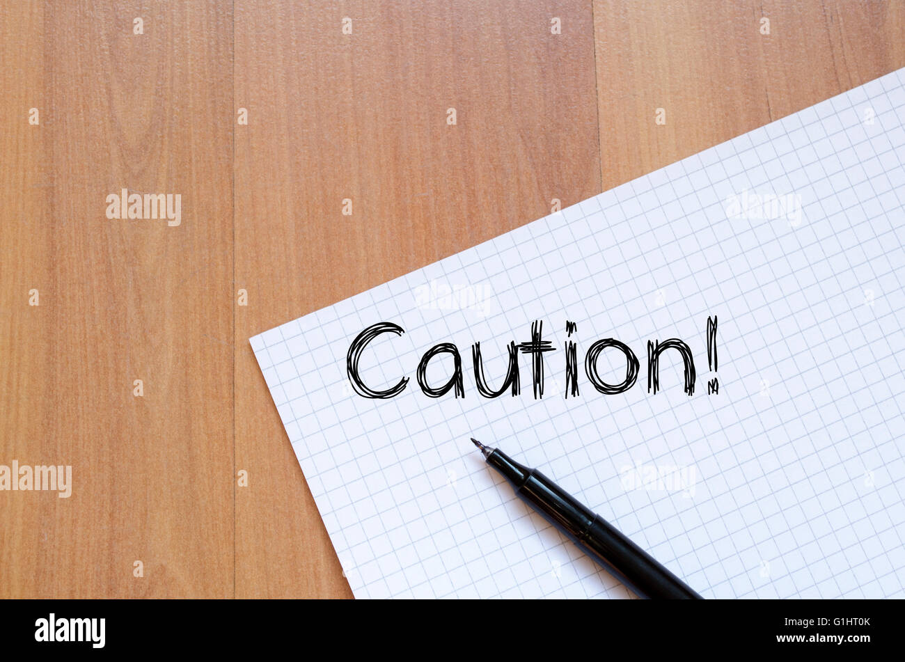 Caution text concept write on notebook Stock Photo - Alamy