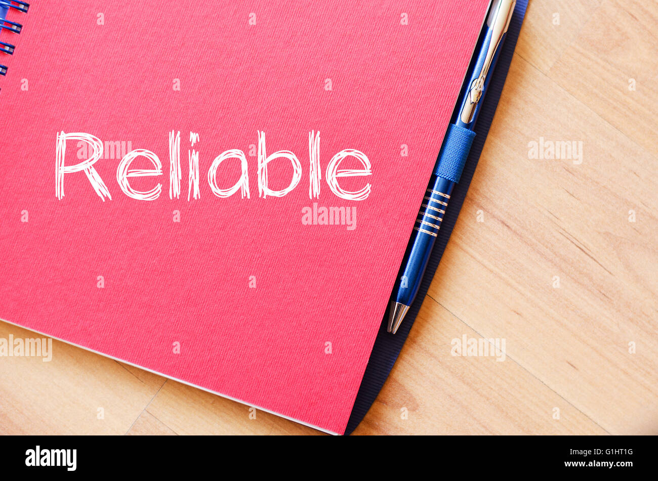 Reliable text concept write on notebook Stock Photo - Alamy