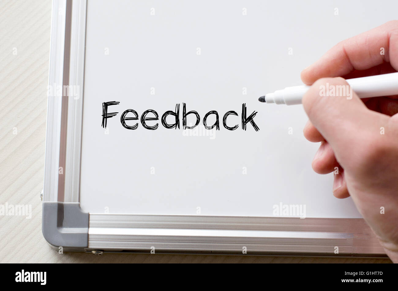 Human hand writing feedback on whiteboard Stock Photo - Alamy