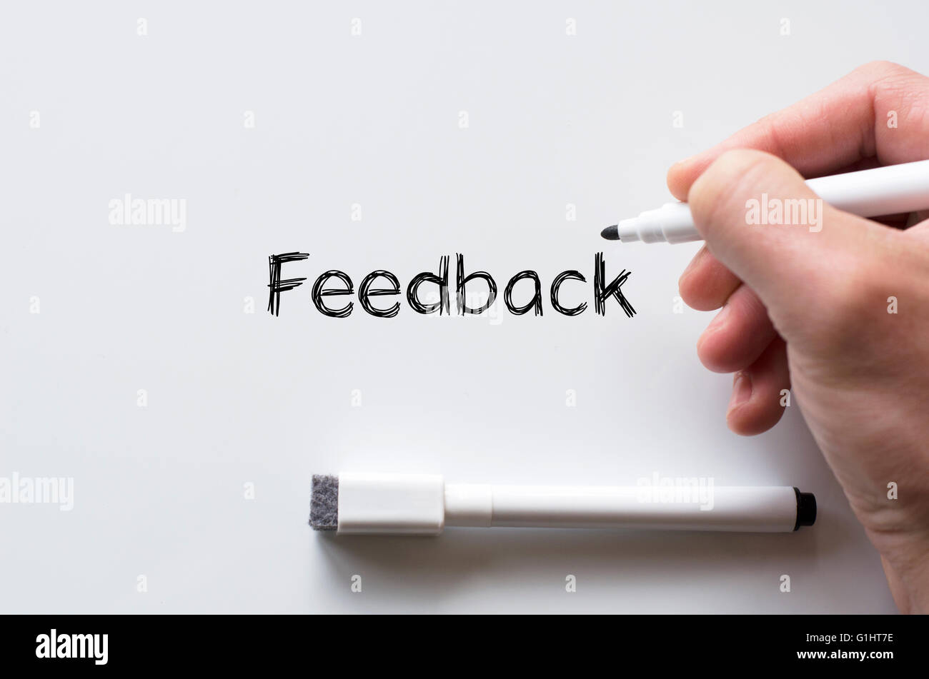 Human hand writing feedback on whiteboard Stock Photo - Alamy