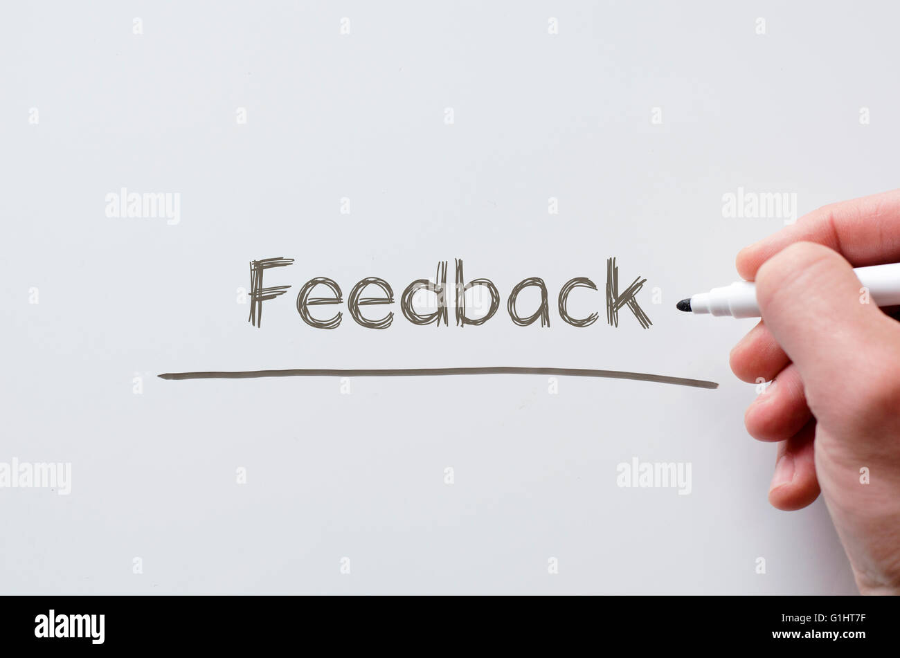 Human hand writing feedback on whiteboard Stock Photo - Alamy
