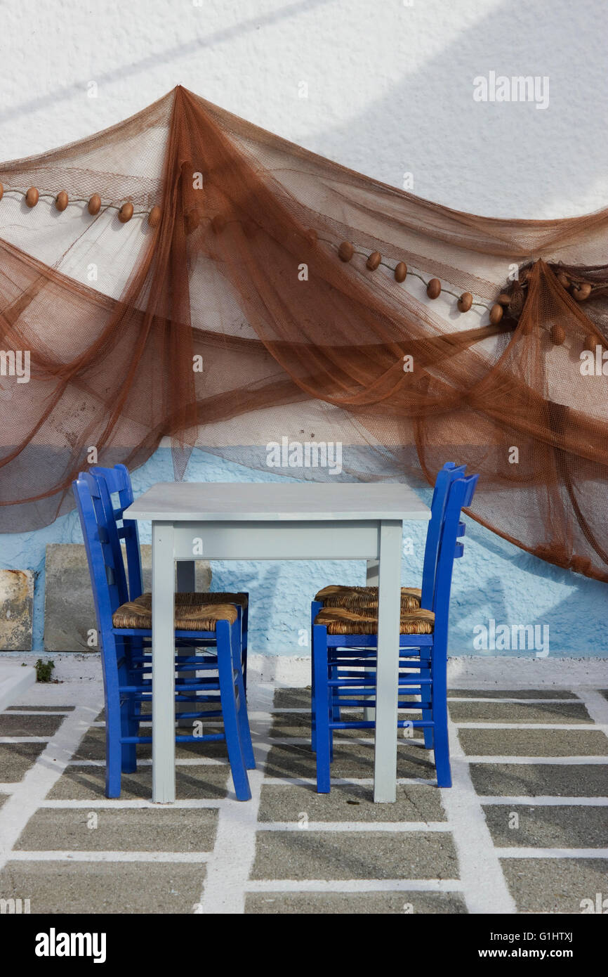 Blue chairs & cyan empty fish restaurant tables on whitewash chequered ...