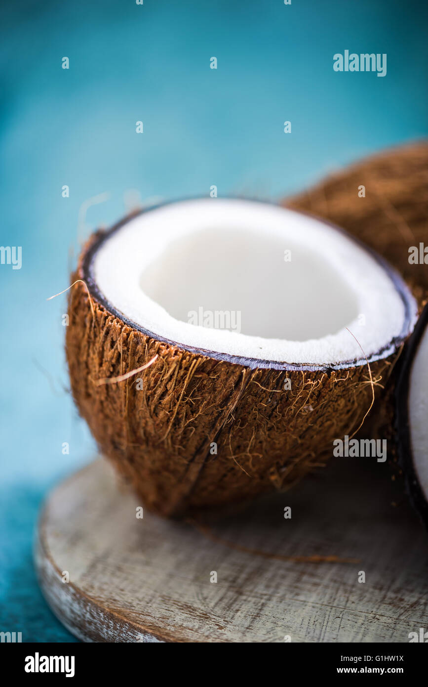 coconut cut in half on vibrant background with copy space Stock Photo ...
