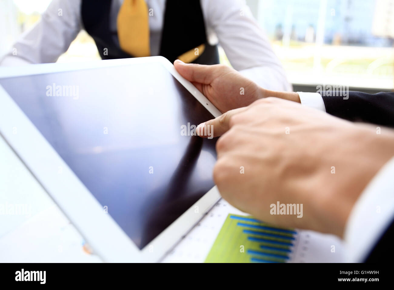Businessman finger pointing to the screen of tablet-pc Stock Photo - Alamy