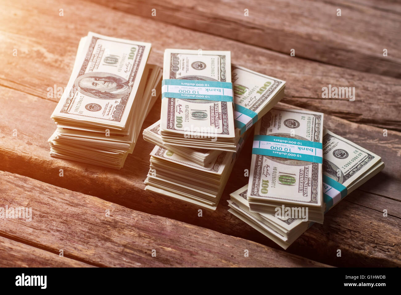 Dollar bundles on wooden background Stock Photo - Alamy