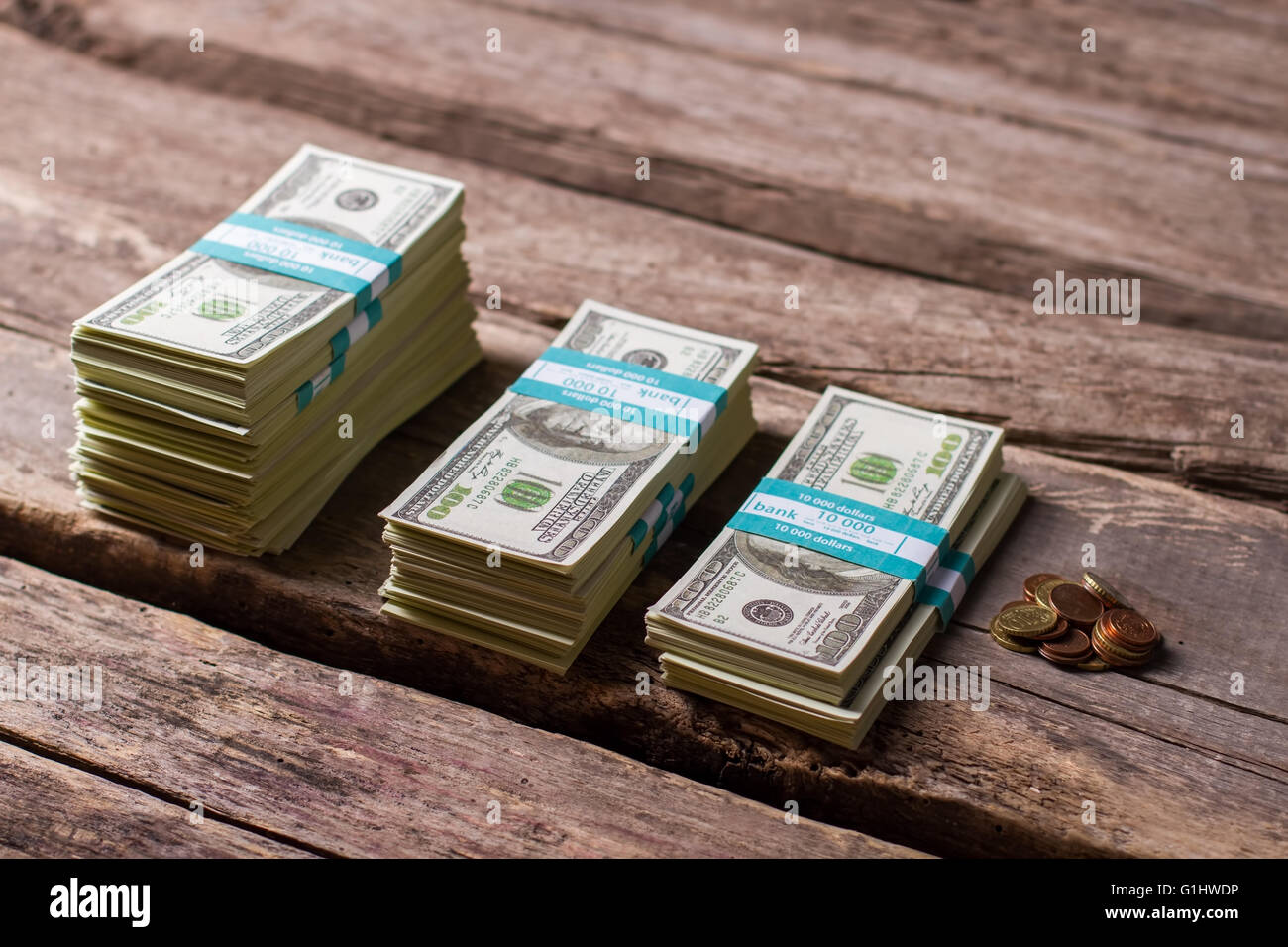 Dollar bundles and coins Stock Photo - Alamy