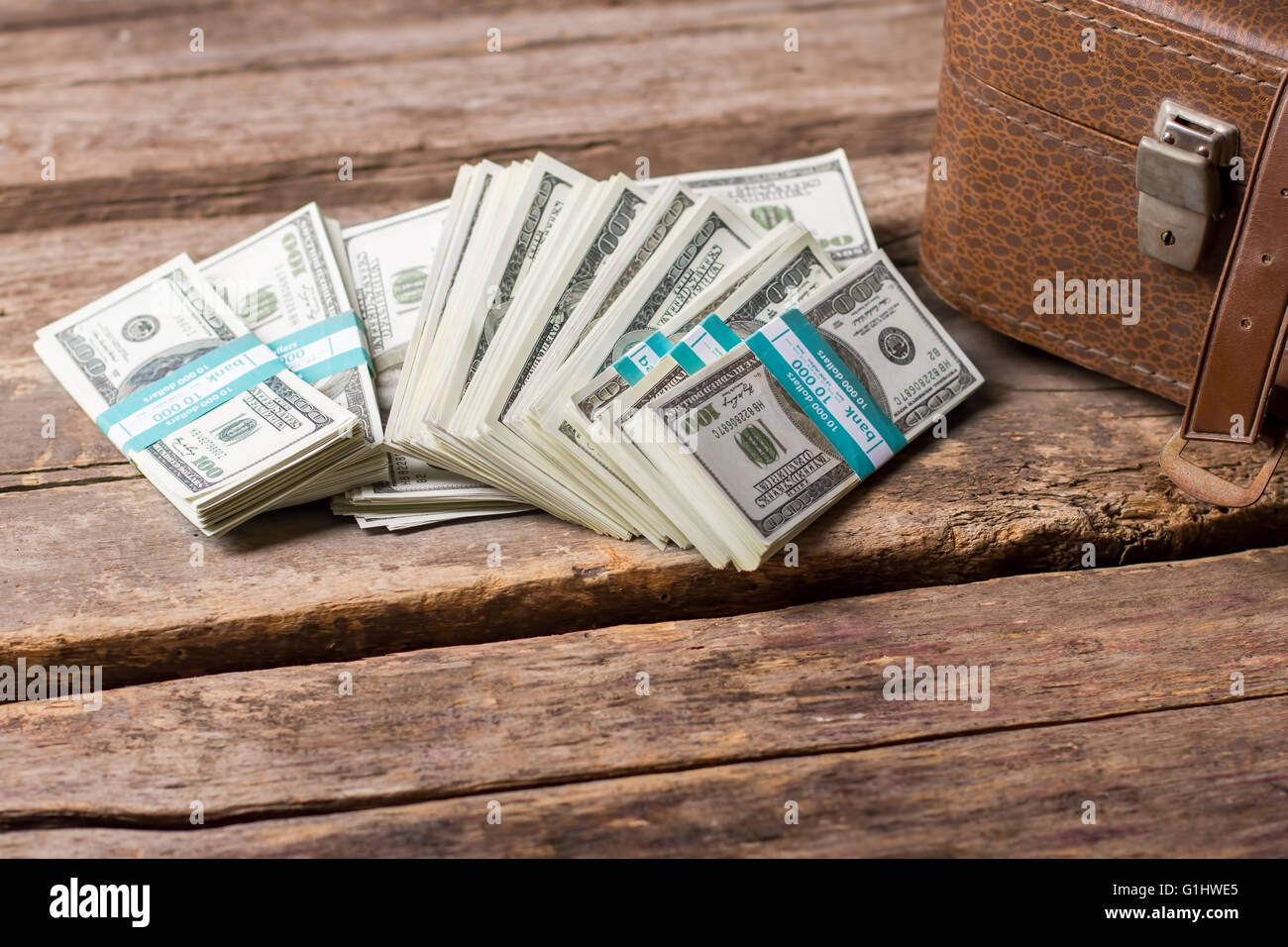 Dollar bundles and brown case Stock Photo - Alamy
