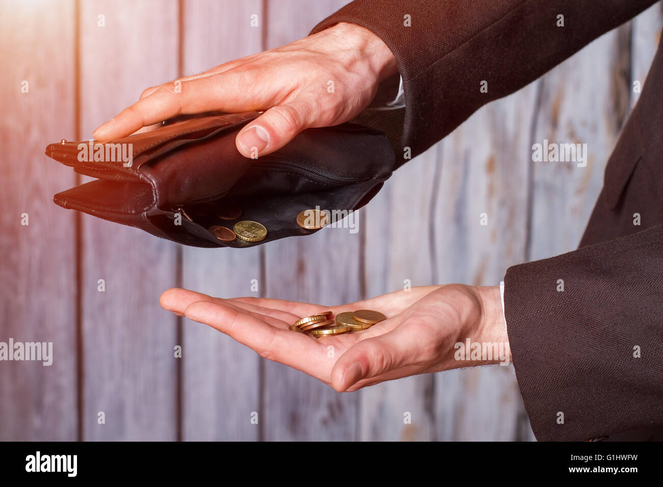 Hands holding coins and wallet Stock Photo - Alamy
