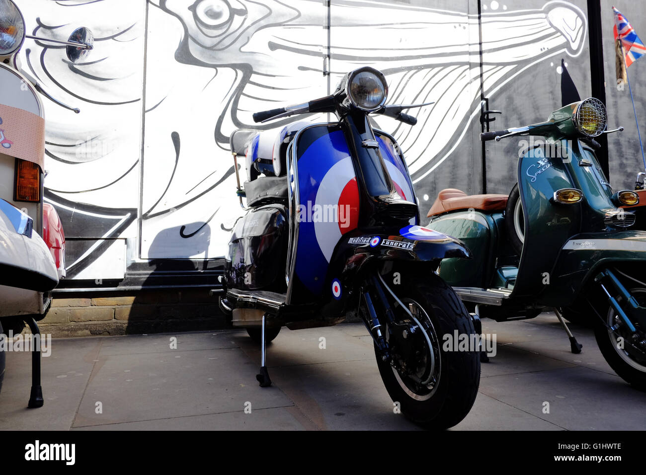 classic mopeds parked on a narrow pavement in the east end of London ...