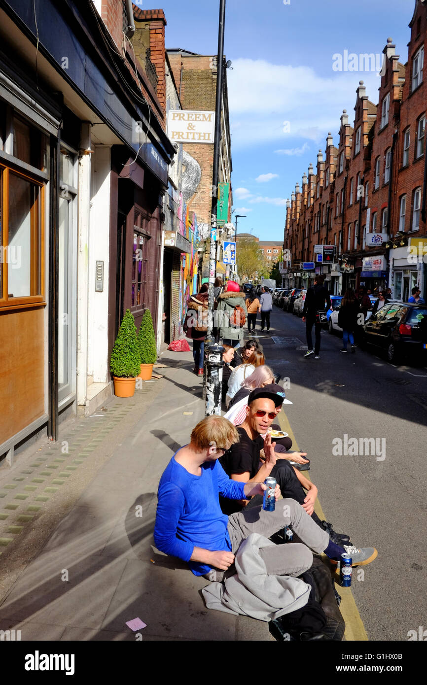Drinking sitting on street hi-res stock photography and images - Alamy