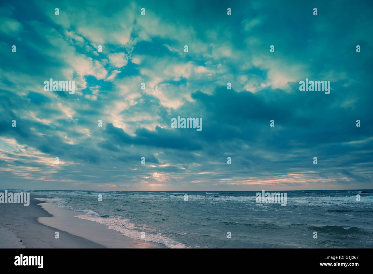 Evening on the beach. Dramatic cloudy sky over sea Stock Photo - Alamy