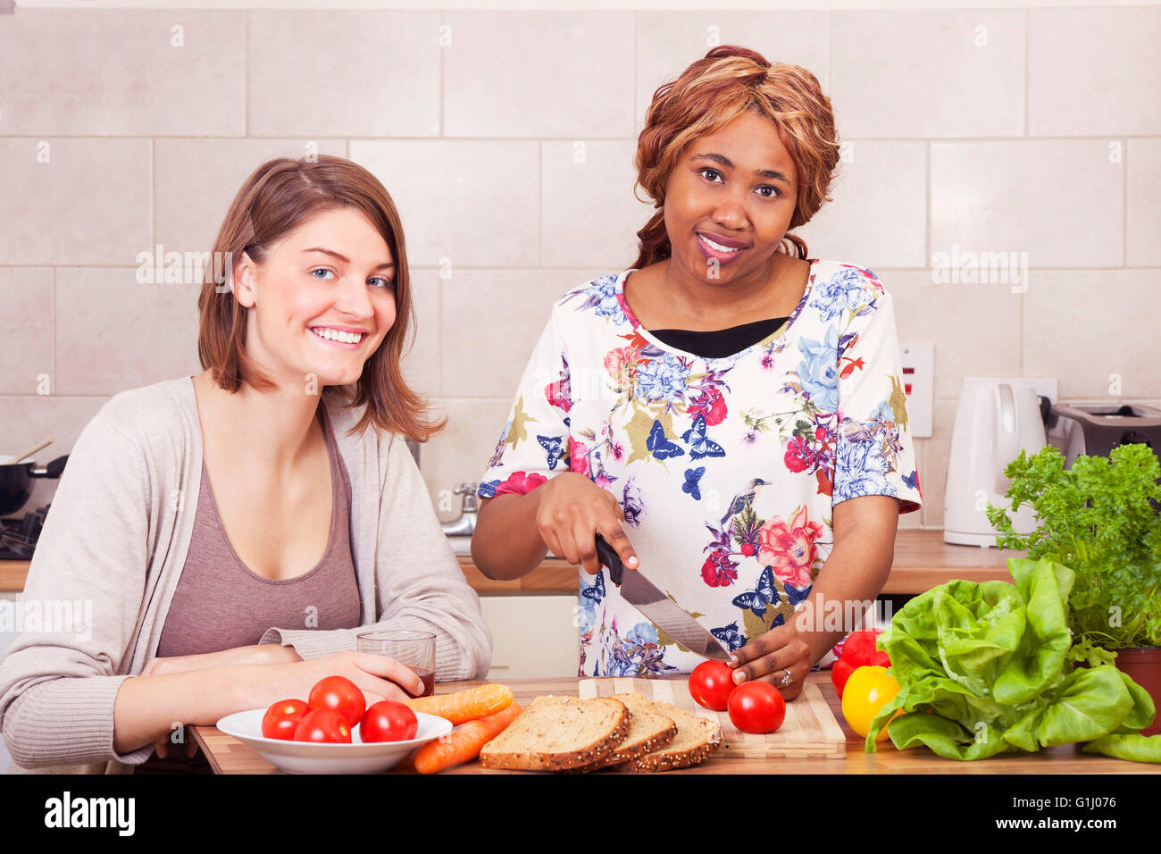 Happy friends cooking together Stock Photo - Alamy