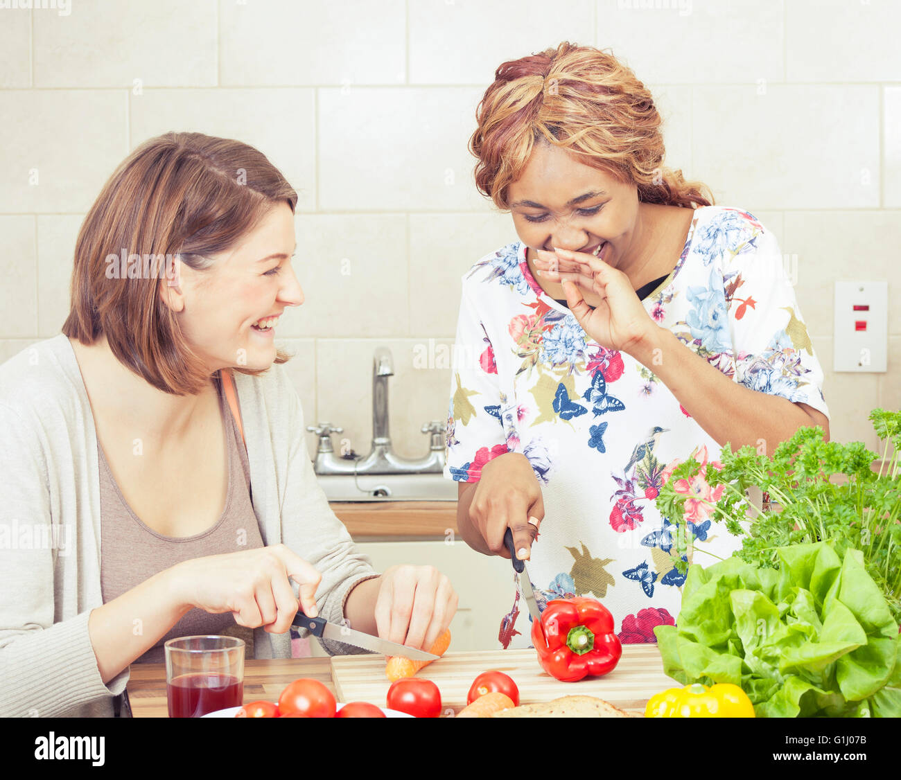 Happy friends cooking together Stock Photo - Alamy