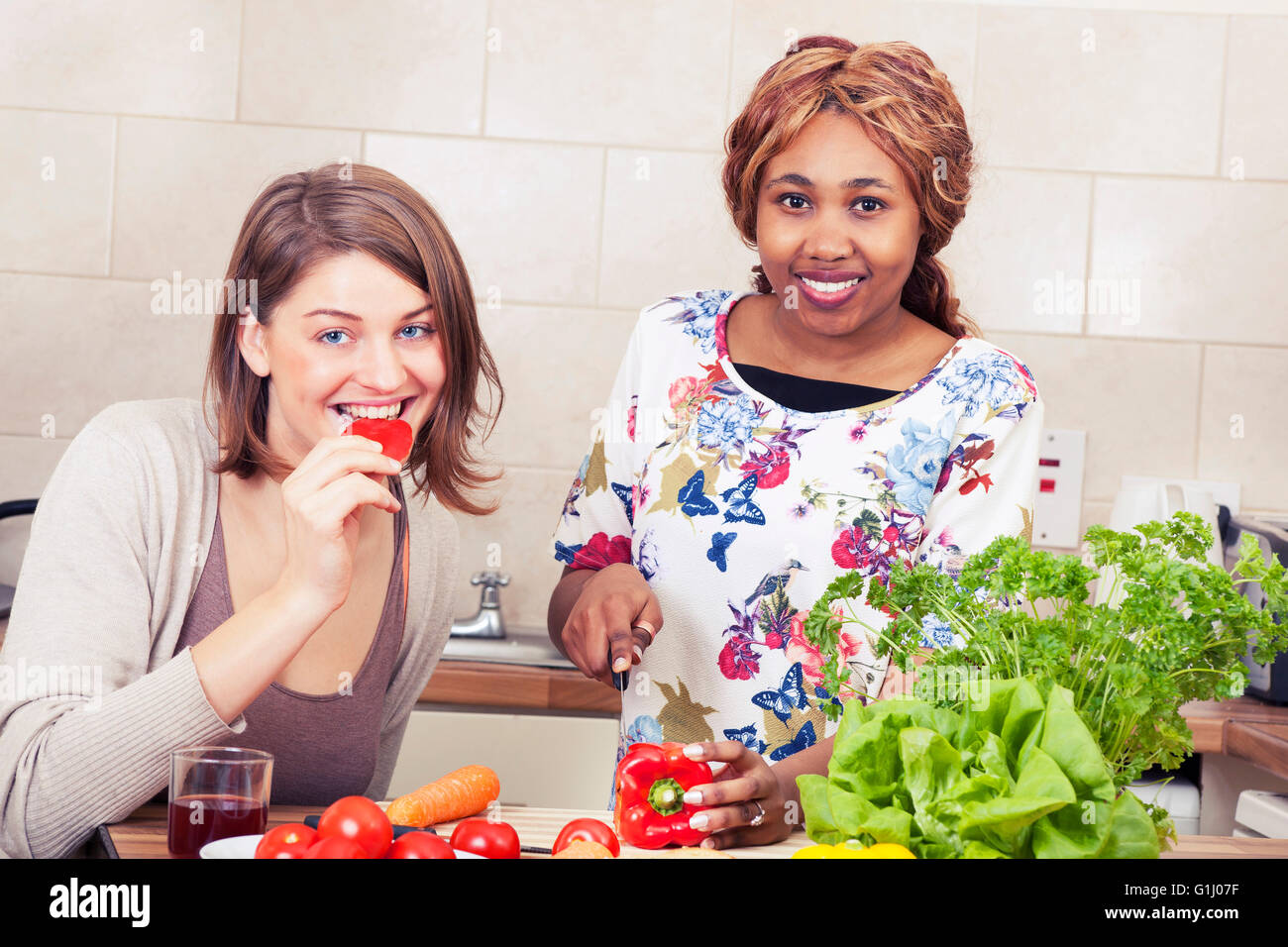 Happy friends cooking together Stock Photo - Alamy