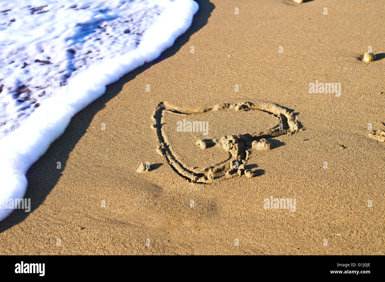 a heart waiting for you on the beach by the sea lit by the sunset Stock ...