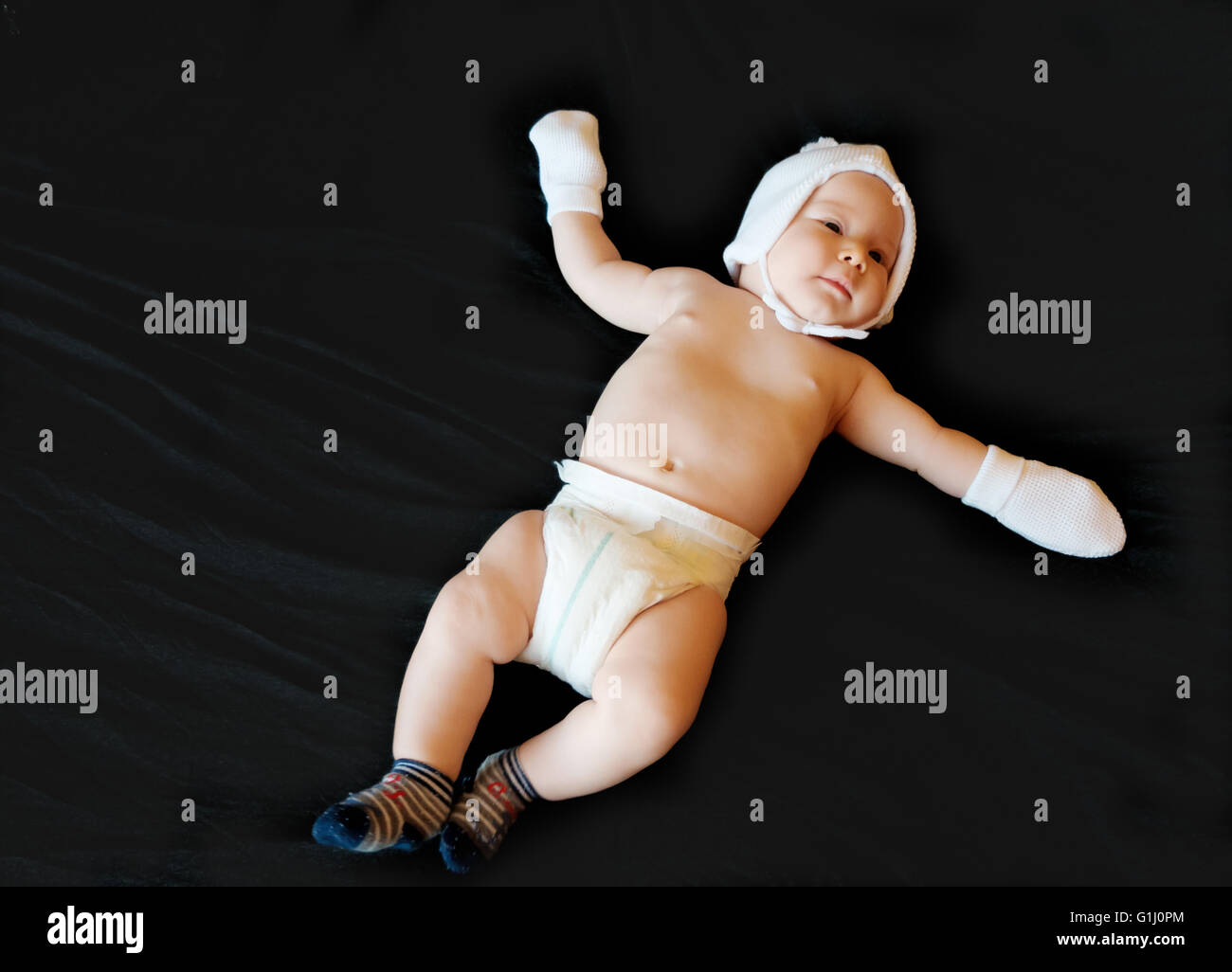 innocent baby on a black background Stock Photo - Alamy