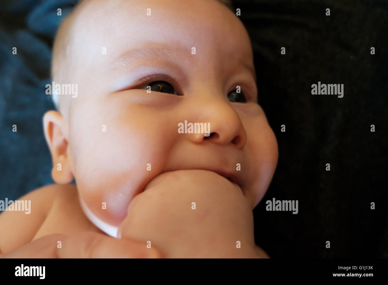 innocent baby on a black background Stock Photo - Alamy
