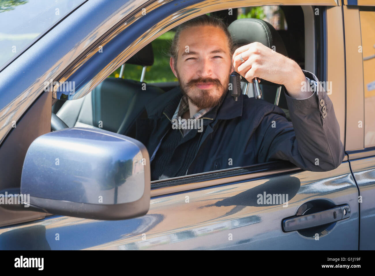 Smiling Asian man with keys as a driver of modern Japanese suv, outdoor ...