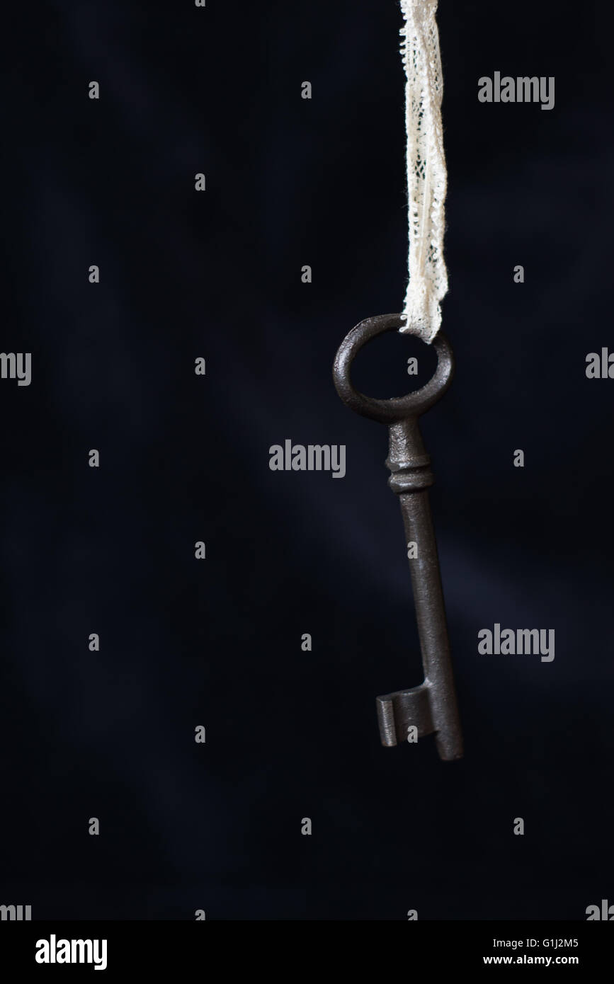 Vintage key hanging on a lace Stock Photo - Alamy